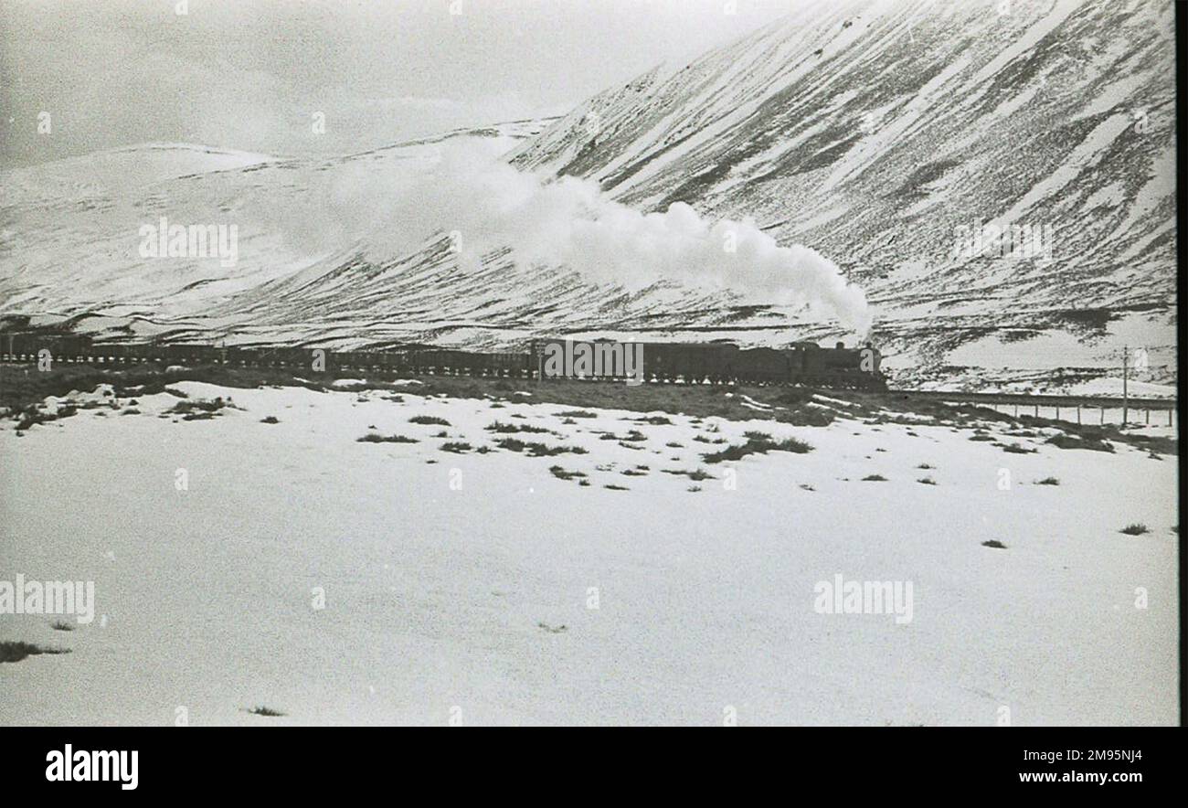 A former Highland Railway 'Big Ben' 4-4-0 hauls a large freight train ...