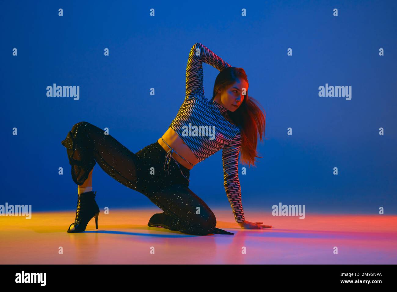 Passion. Portrait of young girl dancing high heel dance in stylish ...