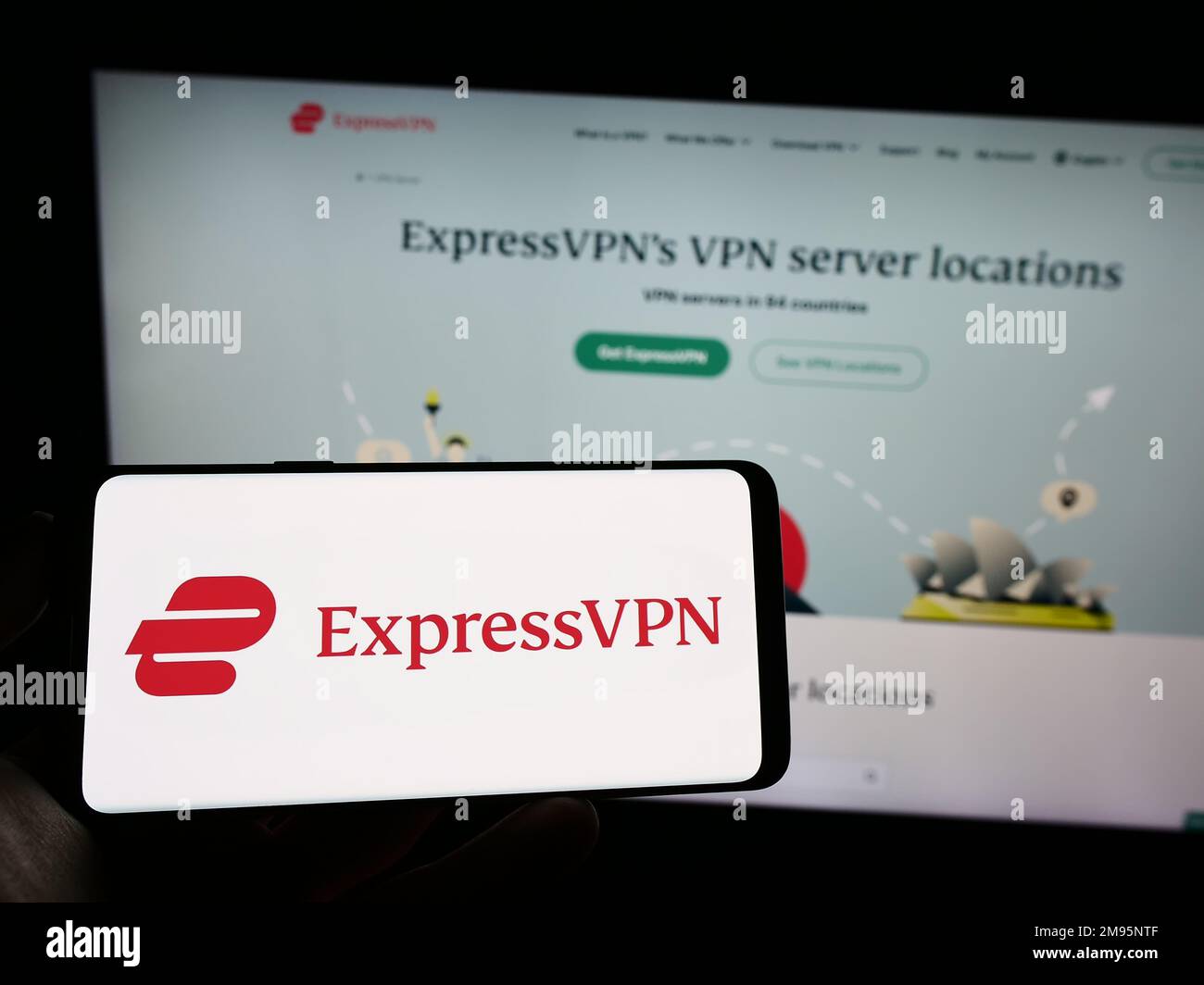 Person holding cellphone with logo of VPN service company ExpressVPN on ...