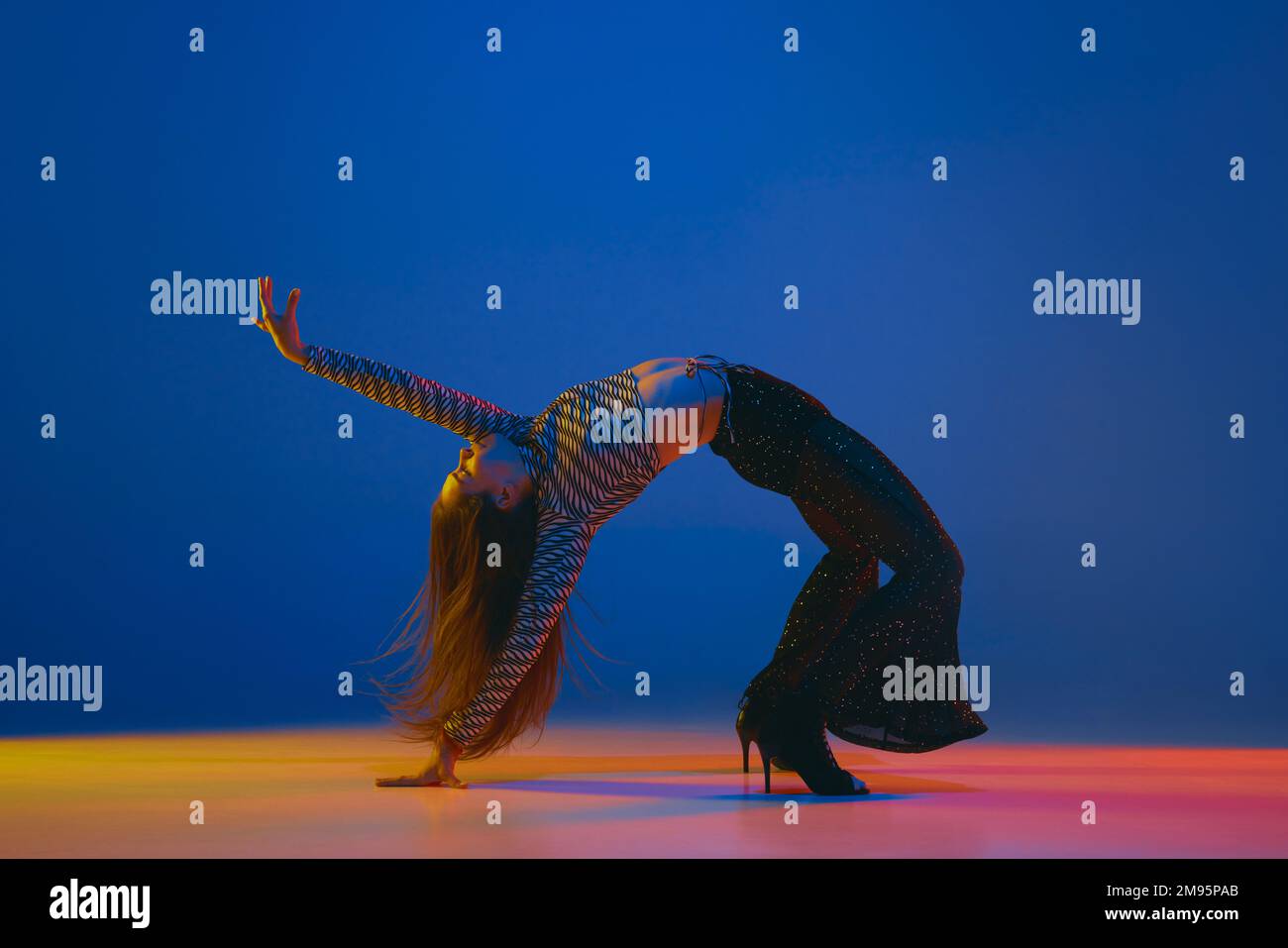 Hobby. Portrait of young girl dancing high heel dance in stylish ...