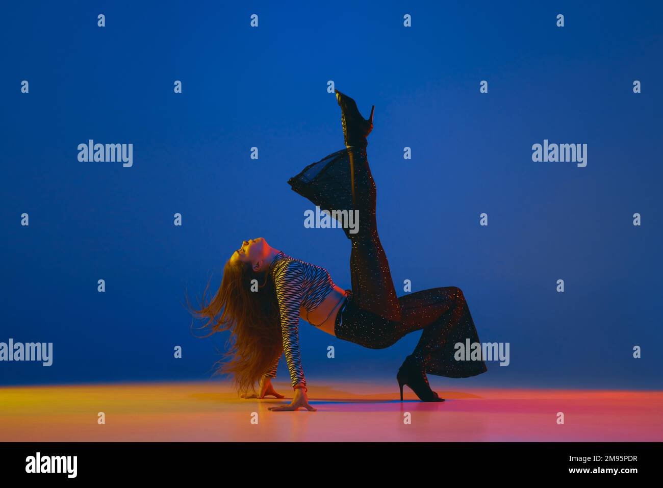 Portrait of young girl dancing, training heels dance in stylish clothes ...