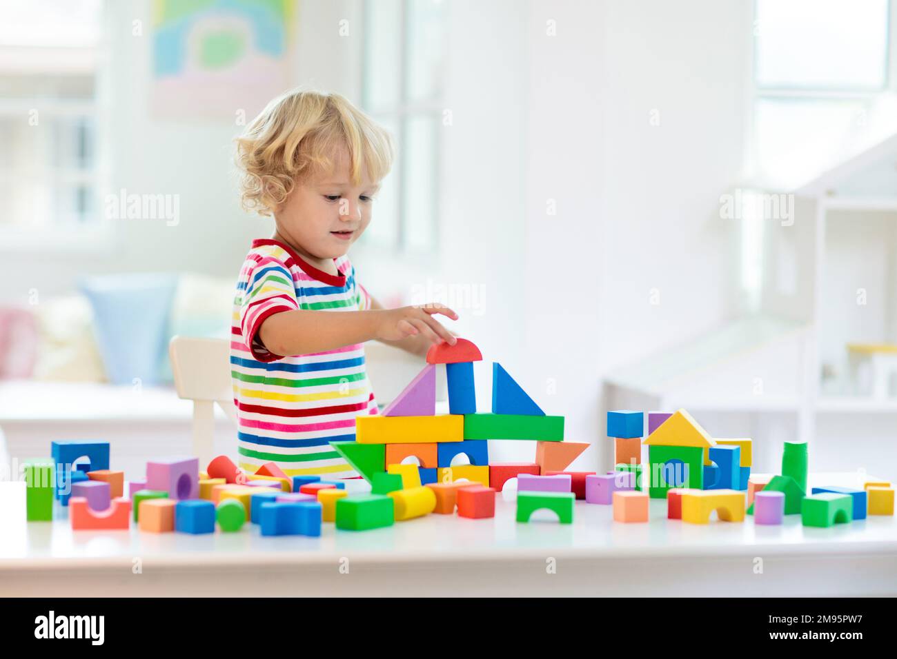 Kid playing with colorful toy blocks. Little boy building tower of ...