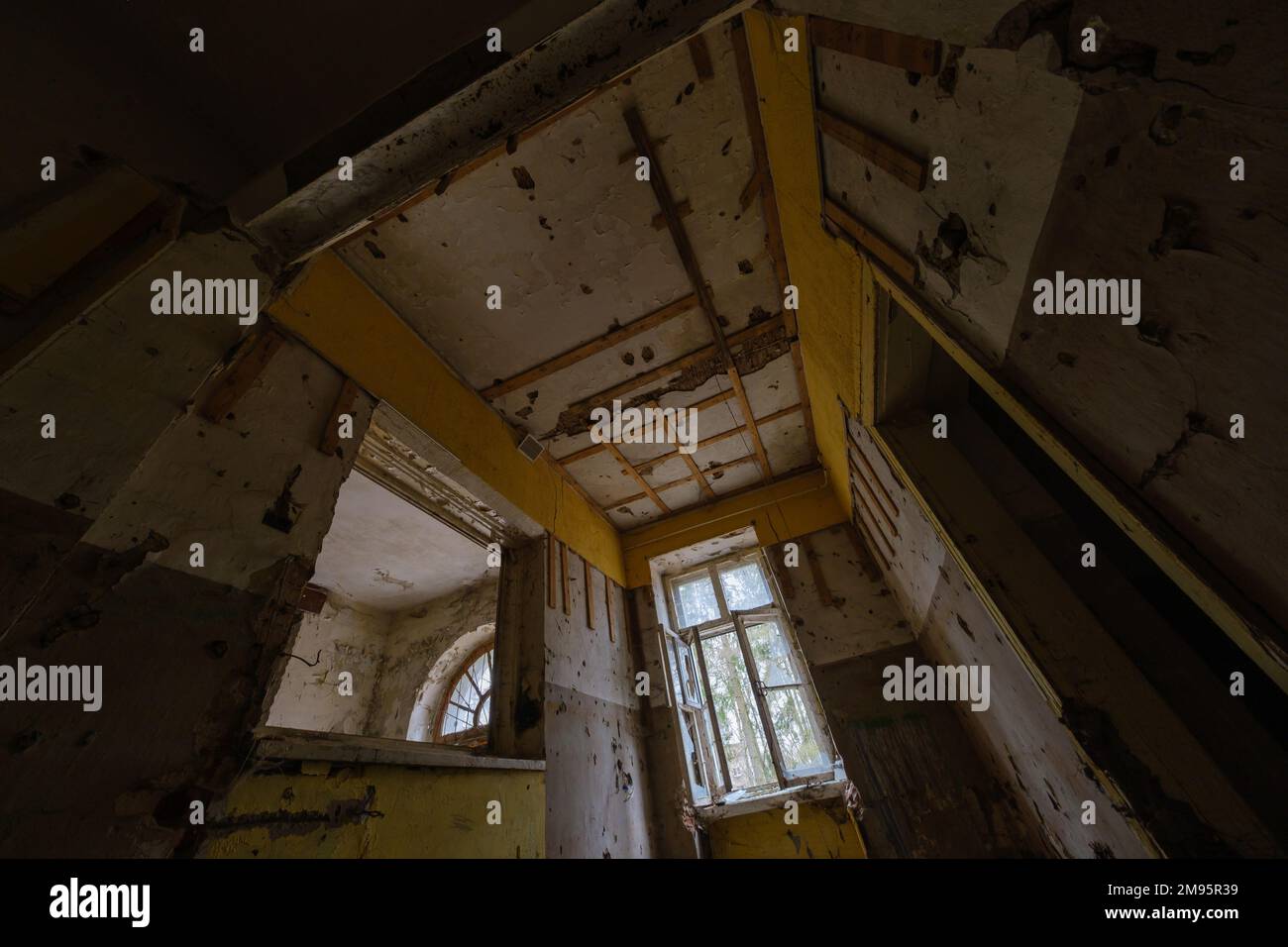 Interior of shabby room of desolate building with crumbling brick walls ...