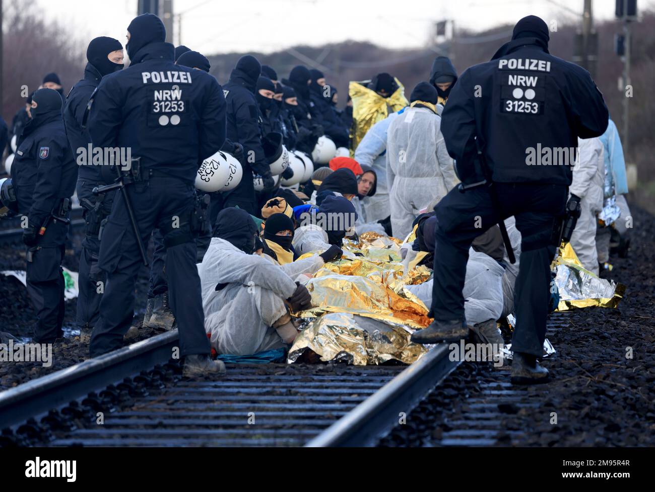 Neurath, Germany. 17th Jan, 2023. Activists block rail tracks to RWE's ...