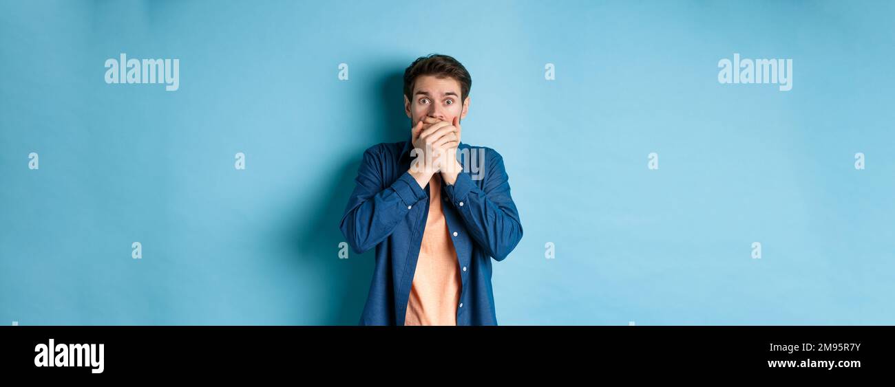 Shocked man covering mouth and gasping ambushed, witness something ...