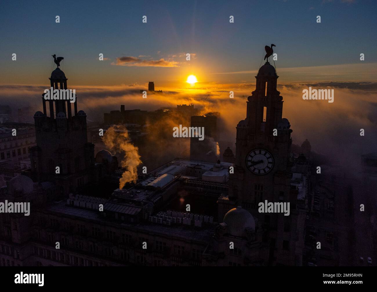 The sun rises behind the Liver Buildings in Liverpool, Merseyside ...