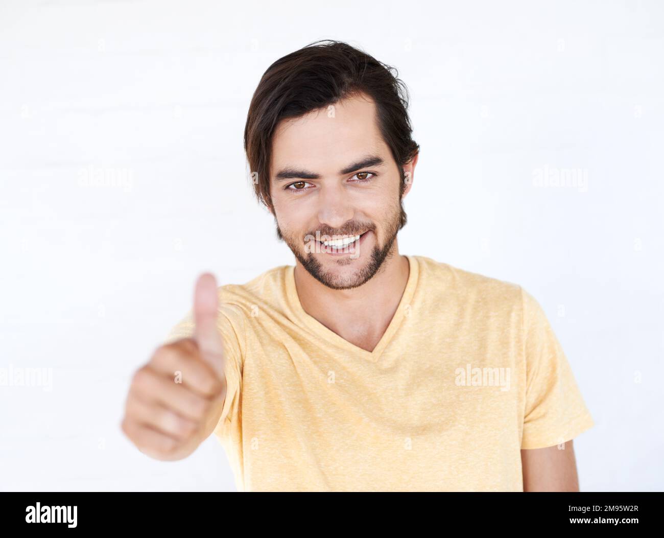 Thumbs up, winner and portrait of man in studio, white background or ...