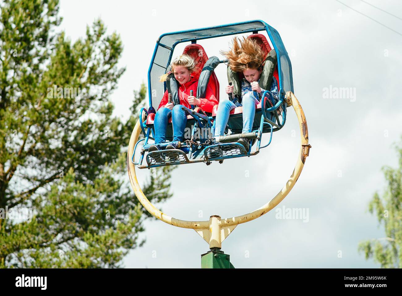 VICHUGA, RUSSIA - JUNE 24, 2017: Two girls ride a carousel in the Park ...