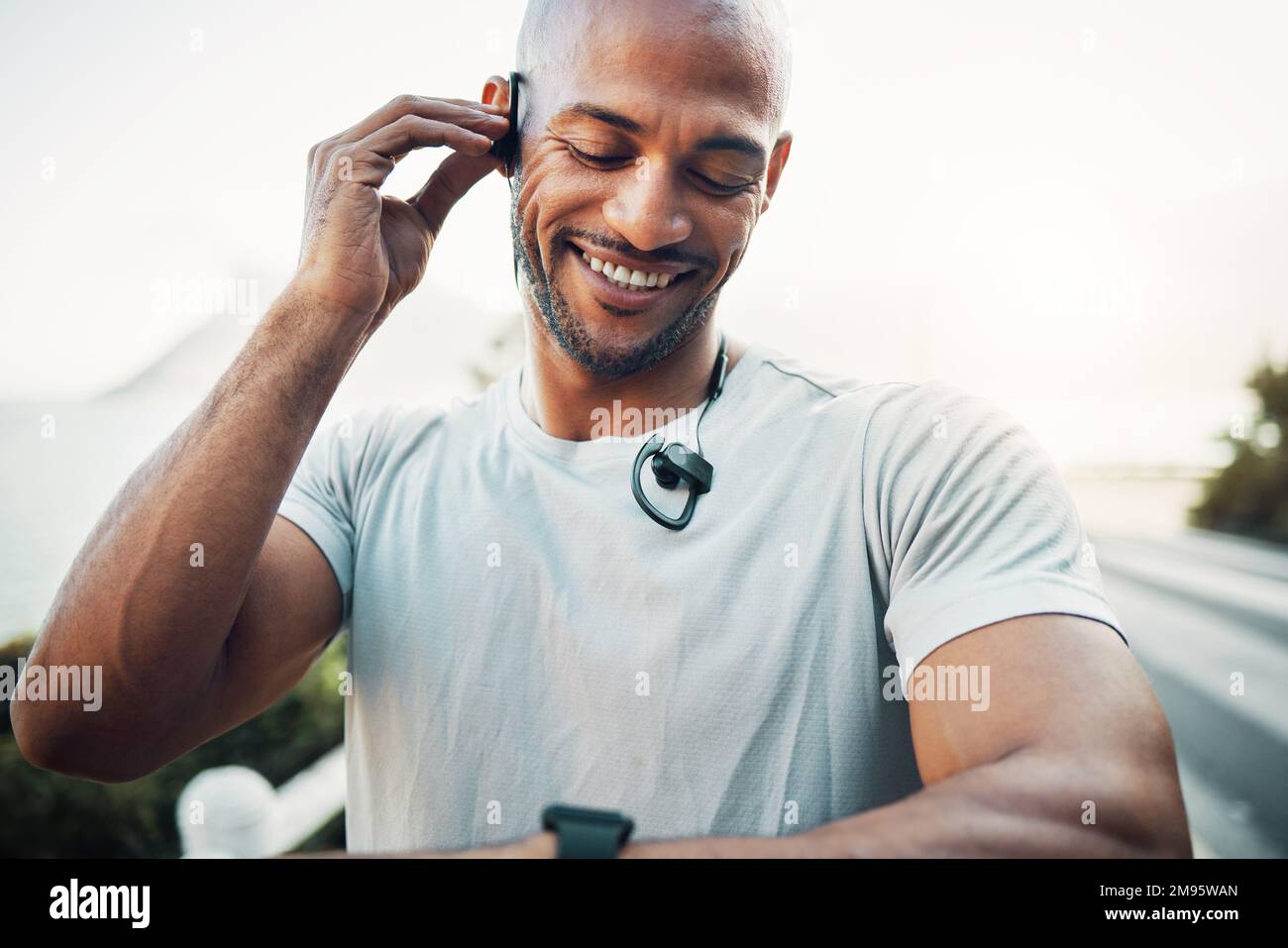 Our bodies are our gardens. a man using his watch to track his pulse ...