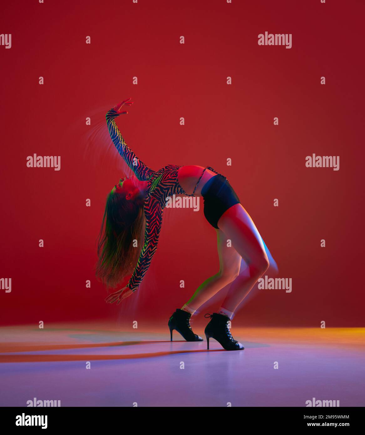 Flexible impression. Portrait of young girl dancing heels dance over ...