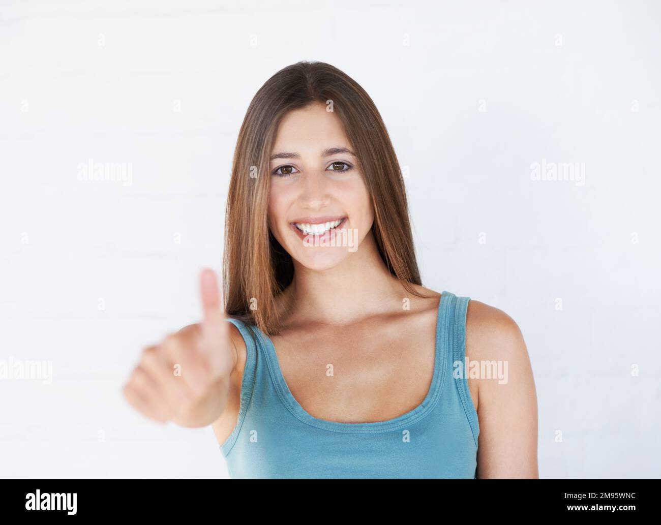 Thumbs up, happy portrait and woman in studio, white background or ...