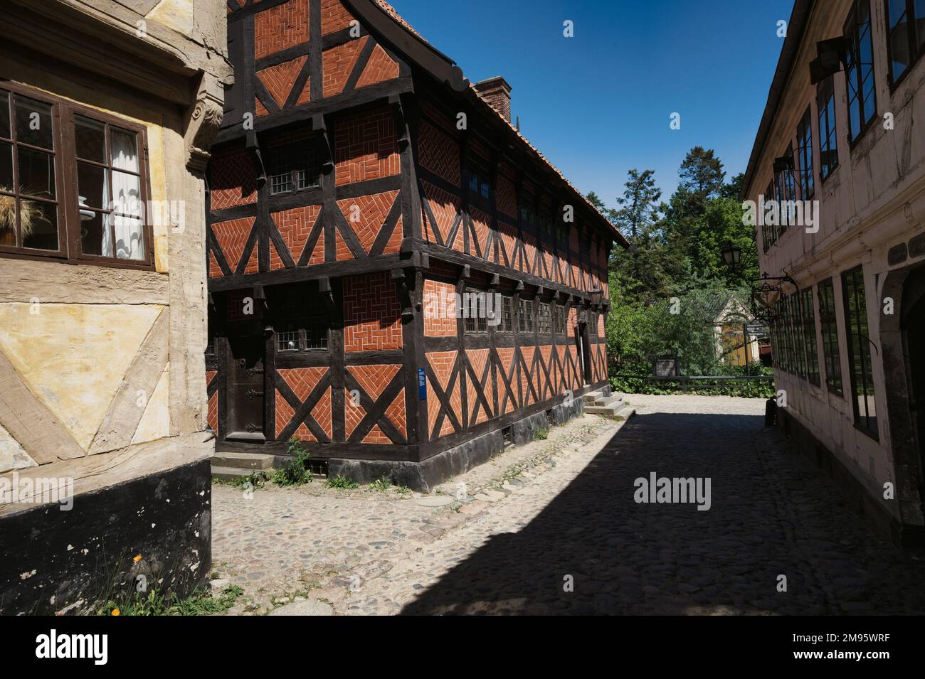 A scene of the narrow street with buildings of the Den Gamle By Museum ...