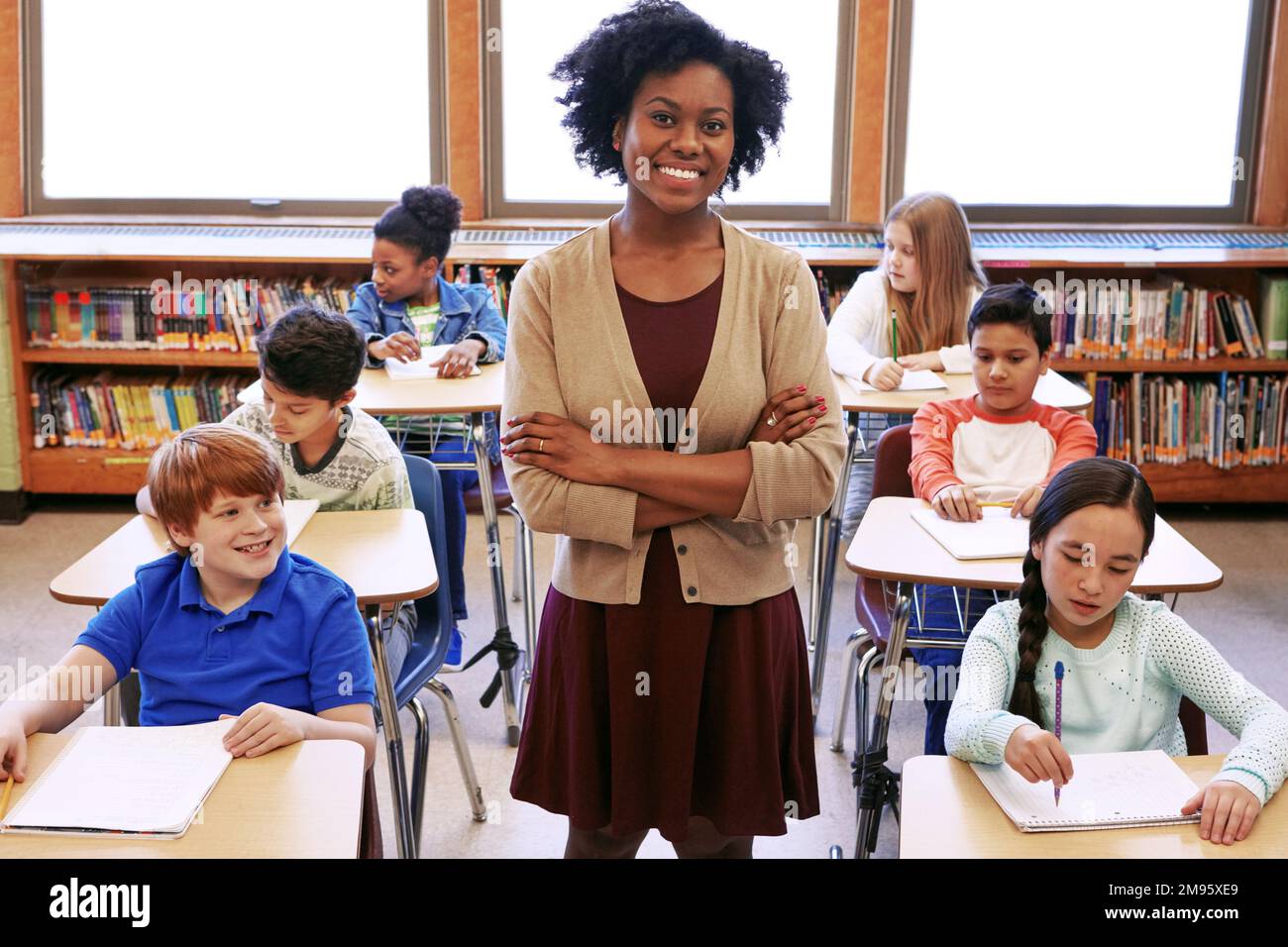 Portrait, black woman and teacher with students learning in classroom ...