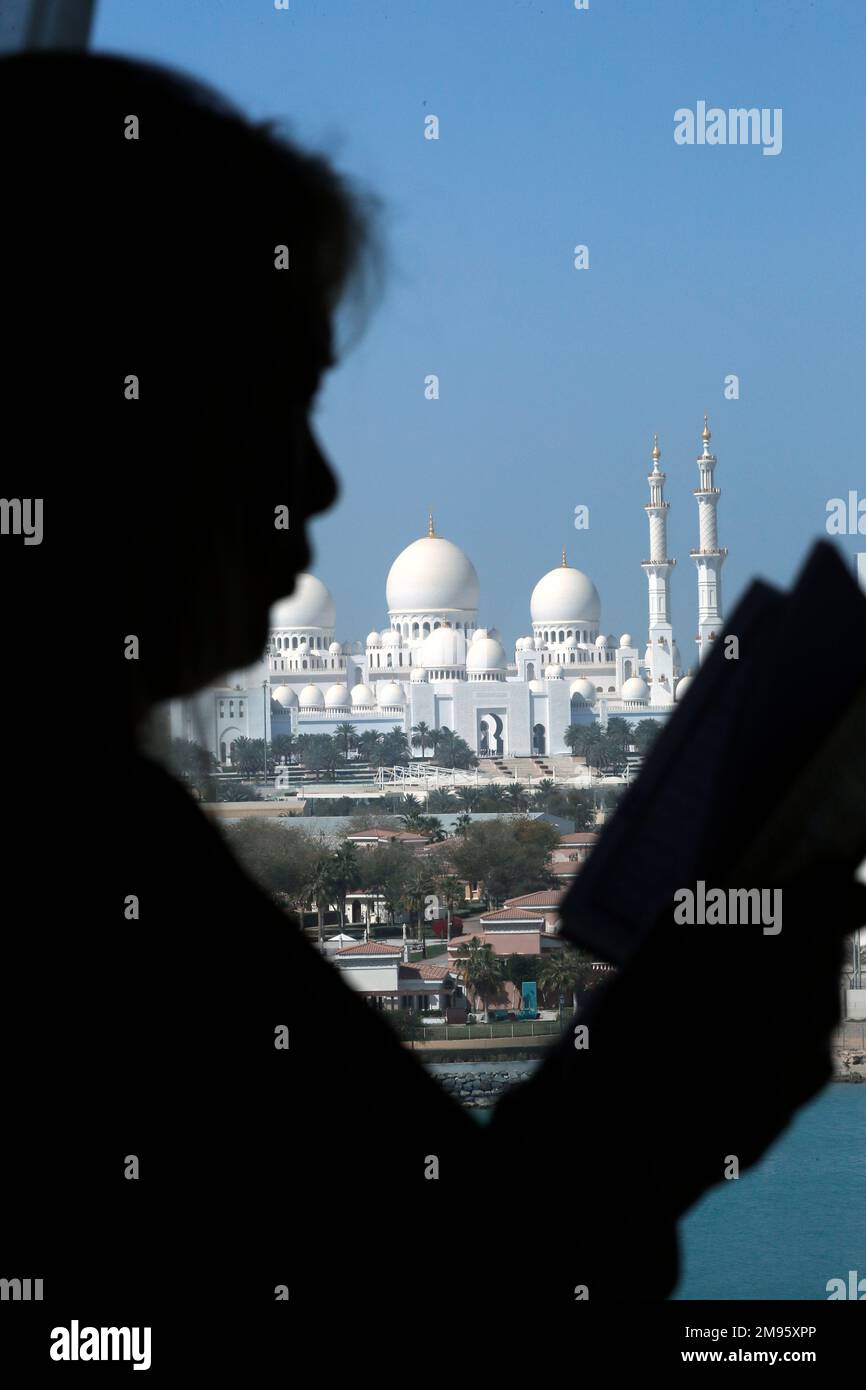 Silhouette of a Muslim woman reading the Holy Quran. Sheikh Zayed Grand ...