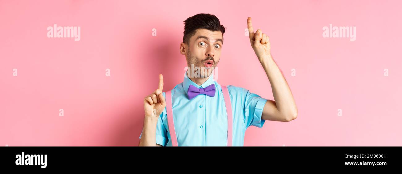 Cheerful funny man dancing in bow-tie and suspenders, pointing fingers ...