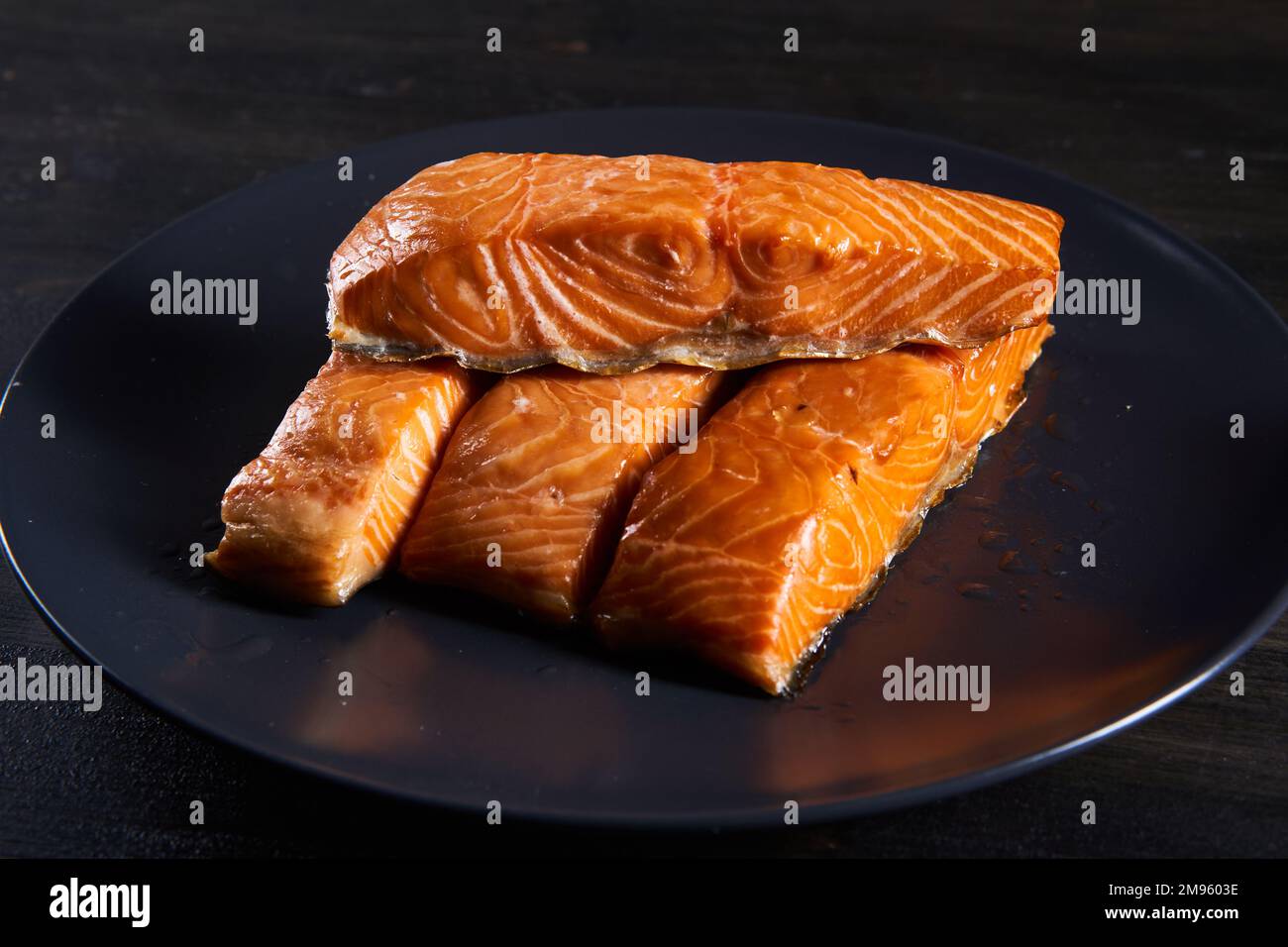 Smoked salmon steaks in closeup on wooden board Stock Photo - Alamy