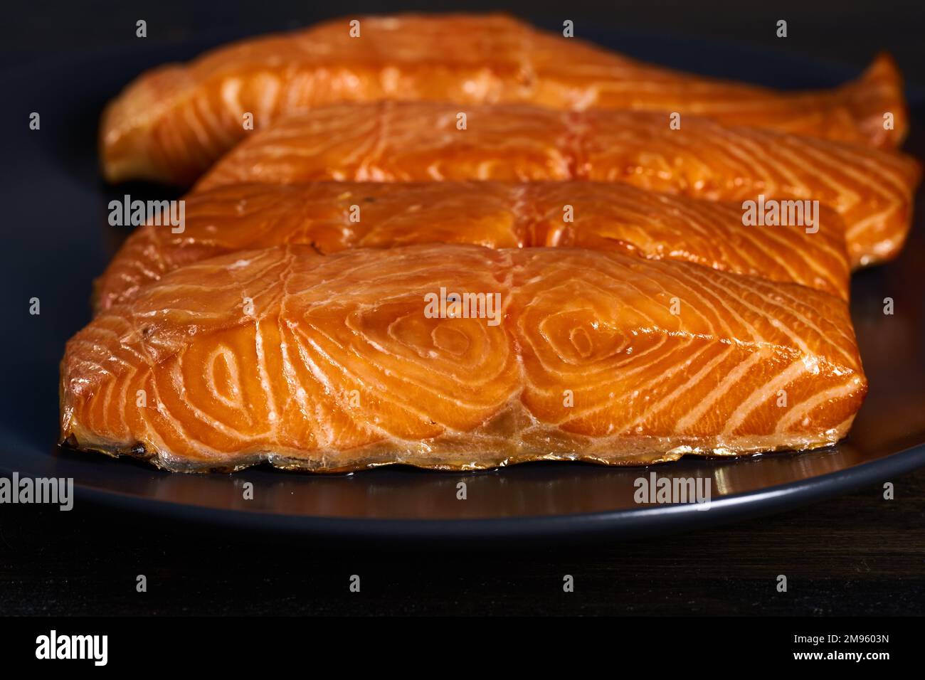 Smoked salmon steaks in closeup on wooden board Stock Photo - Alamy