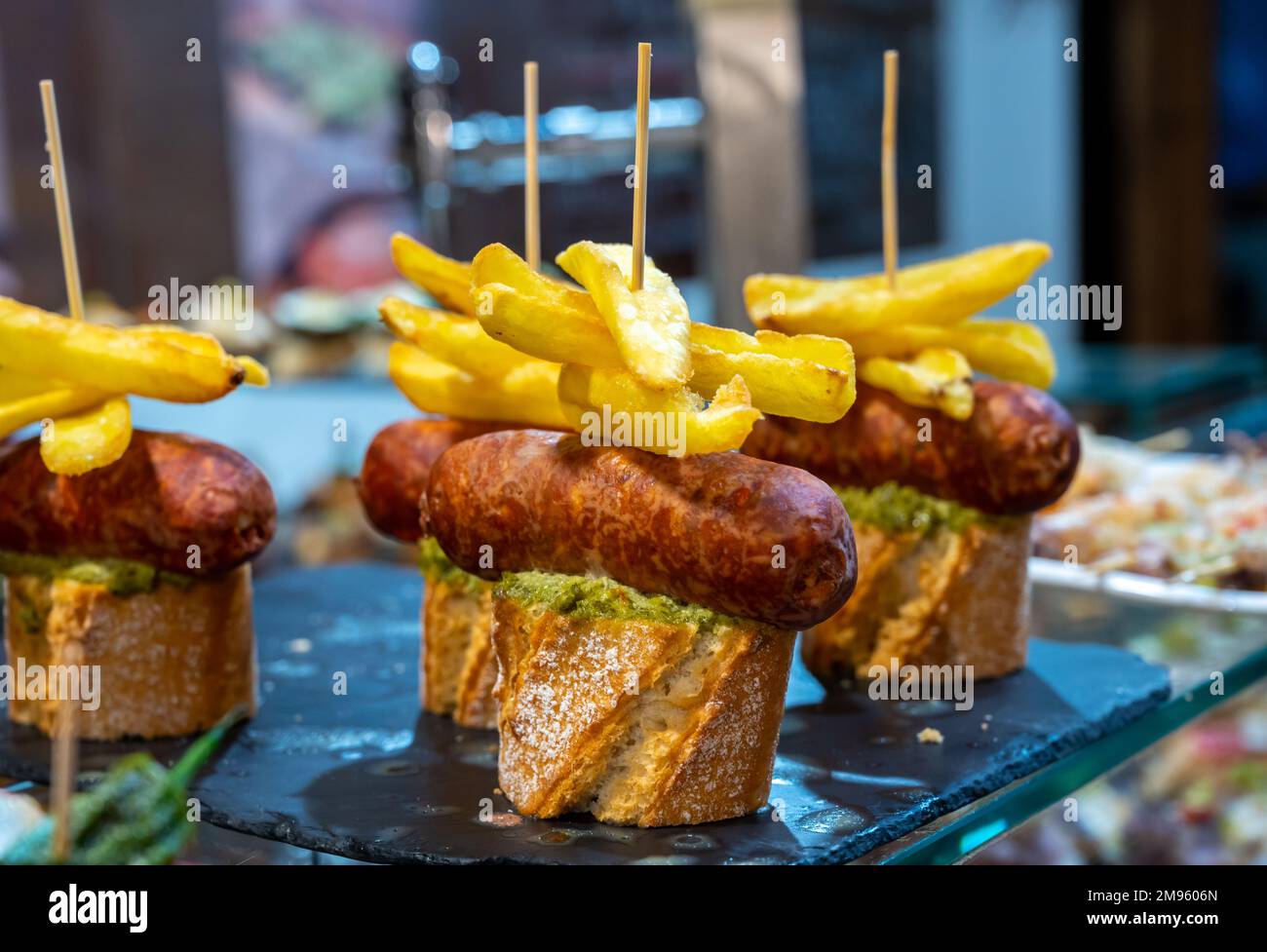 Typical snack of Basque Country, pinchos or pinxtos skewers with small ...