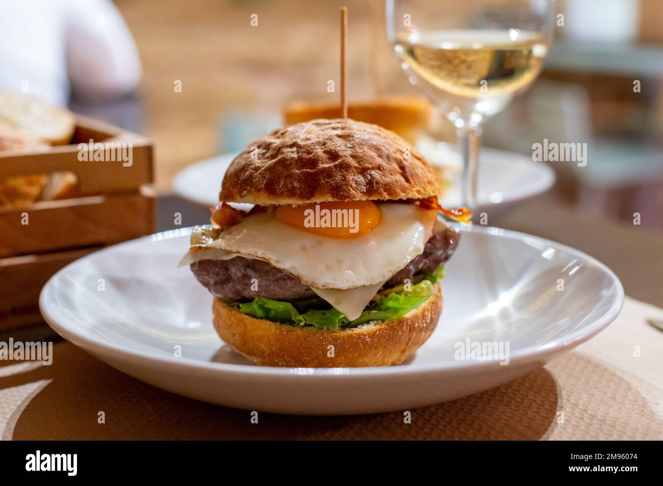 Tasty burger made with white crispy ban, beef burger, egg, green ...