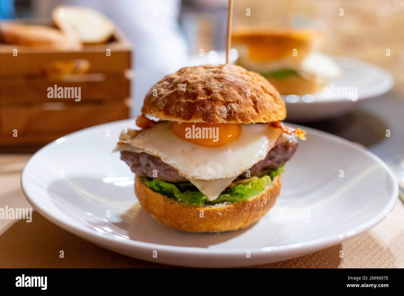 Tasty burger made with white crispy ban, beef burger, egg, green ...