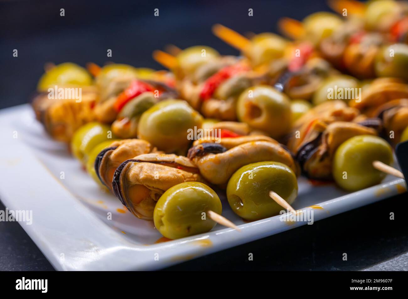 Typical snack of Basque Country, pinchos or pinxtos skewers with small ...