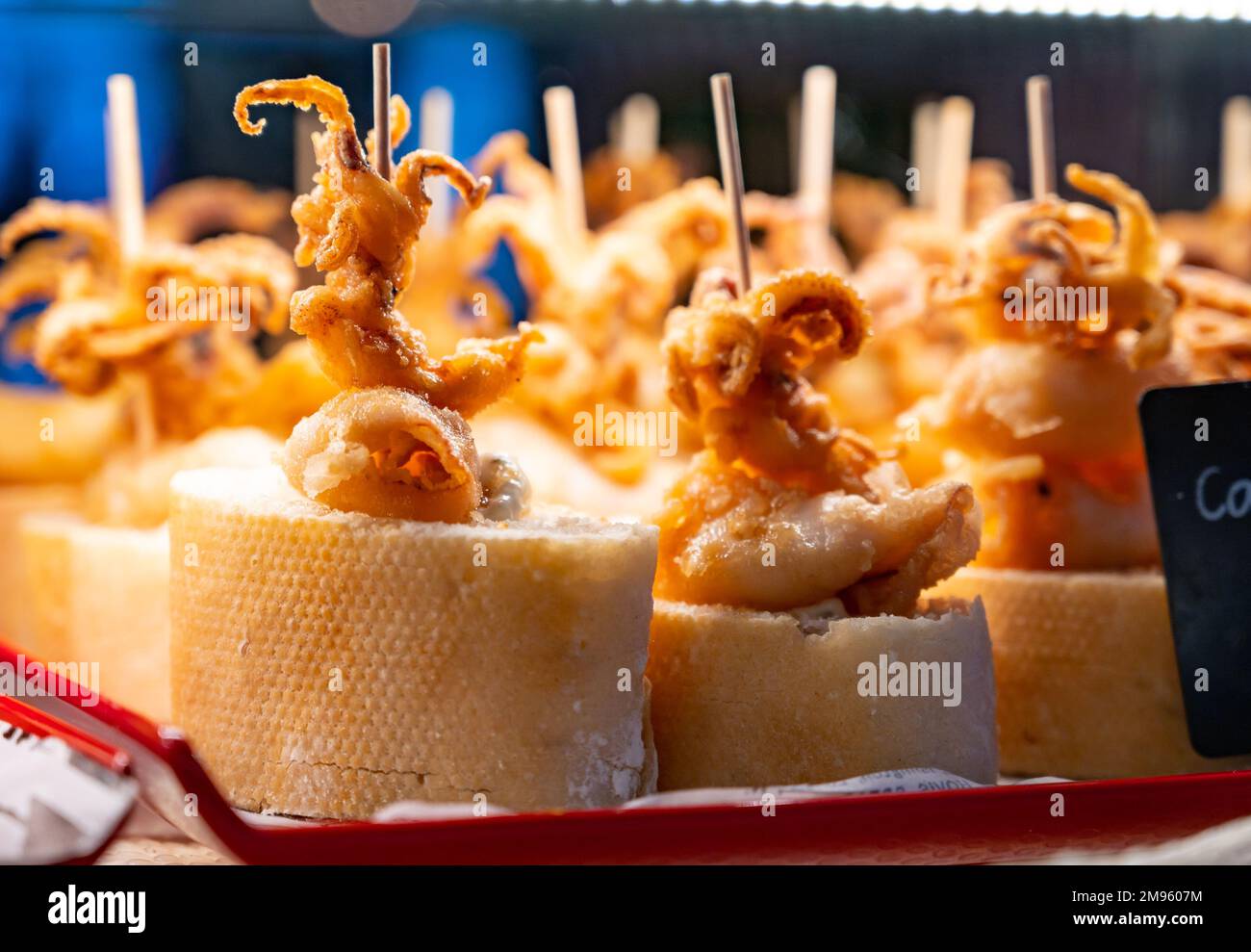 Typical snack of Basque Country, pinchos or pinxtos skewers with small ...