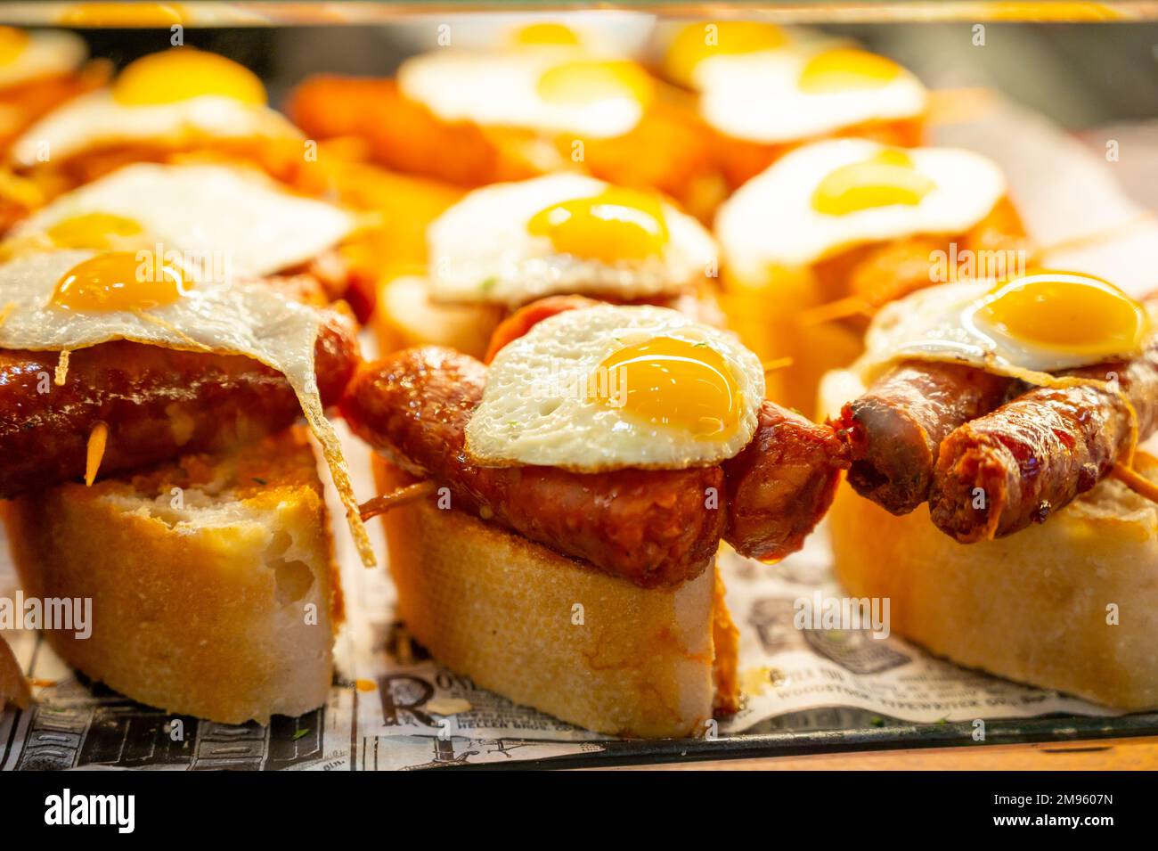 Typical snack of Basque Country, pinchos or pinxtos skewers with small ...