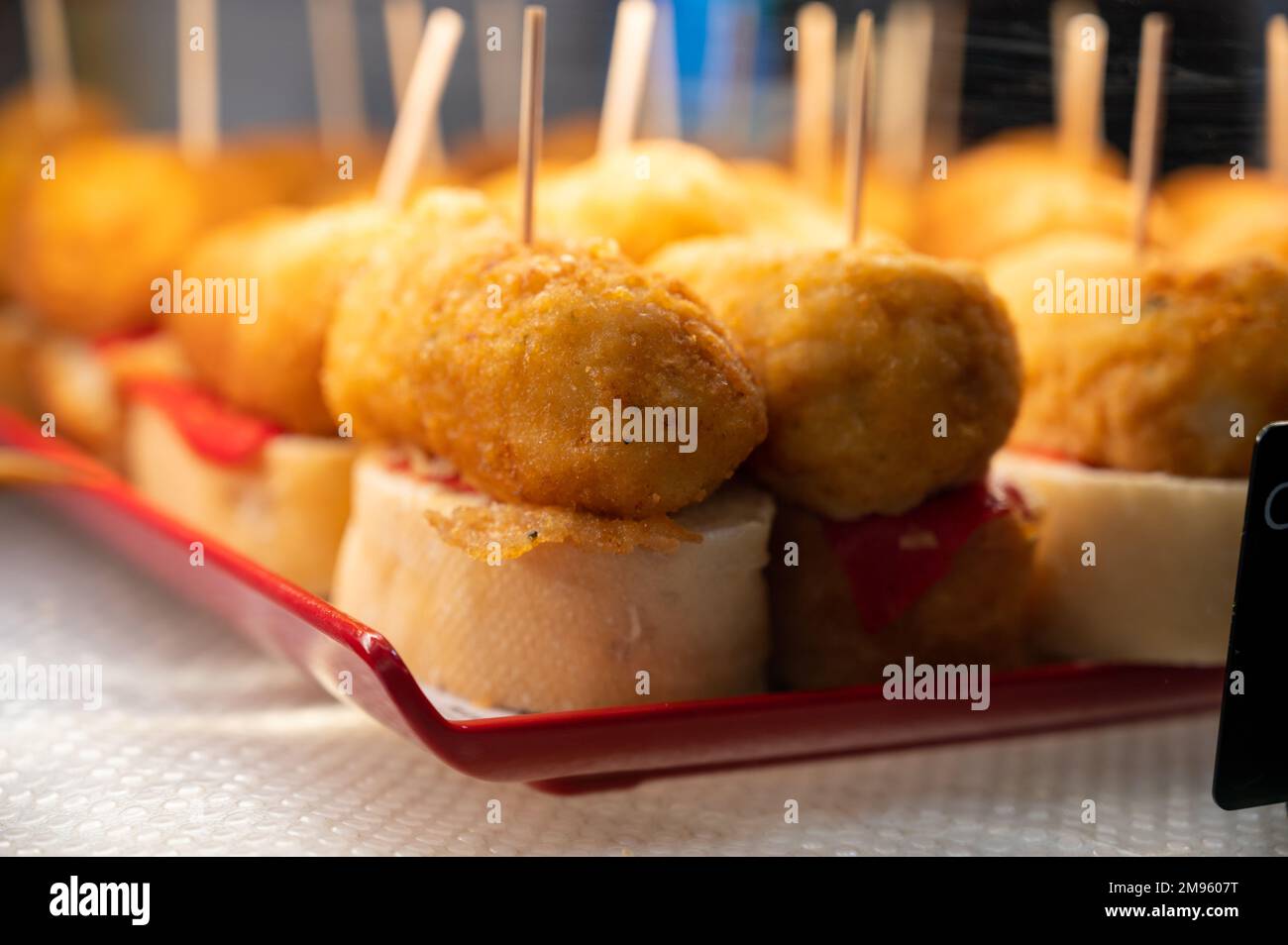 Typical snack of Basque Country, pinchos or pinxtos skewers with small ...