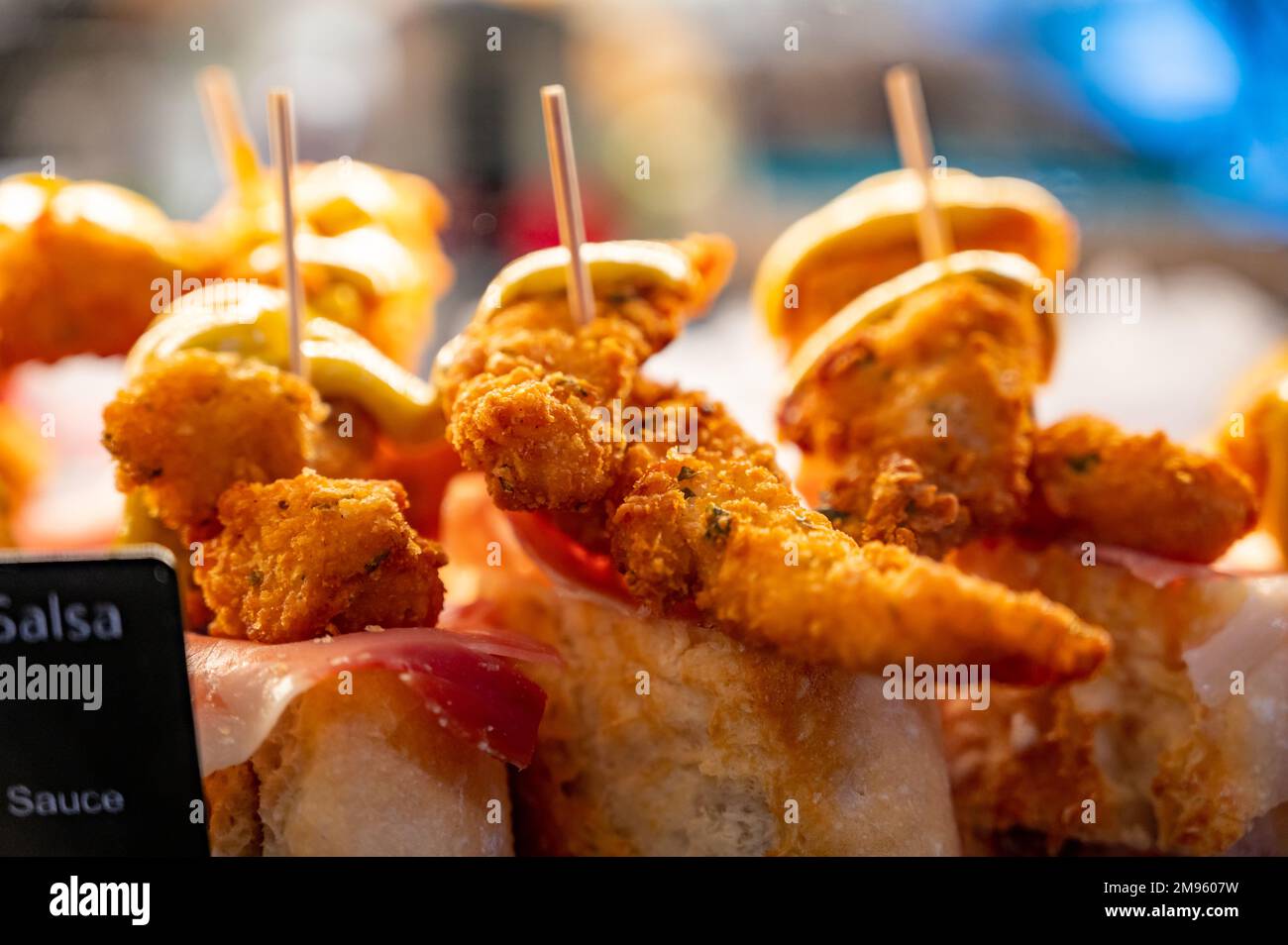 Typical snack of Basque Country, pinchos or pinxtos skewers with small ...