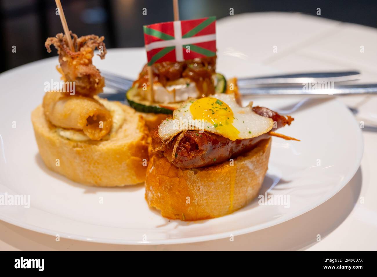 White board with typical snack and flag of Basque Country, pinchos or ...