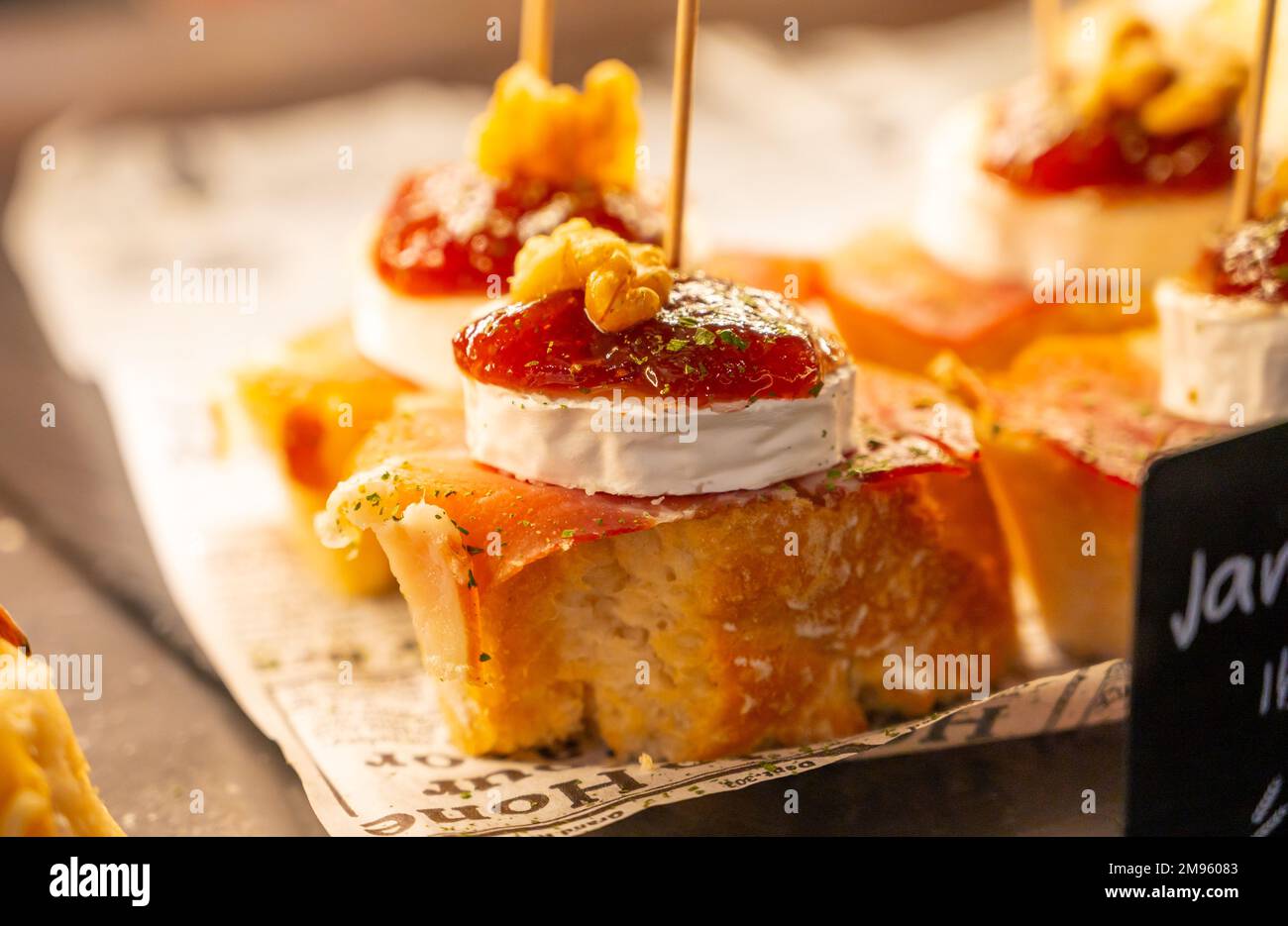 Typical snack of Basque Country, pinchos or pinxtos skewers with small ...