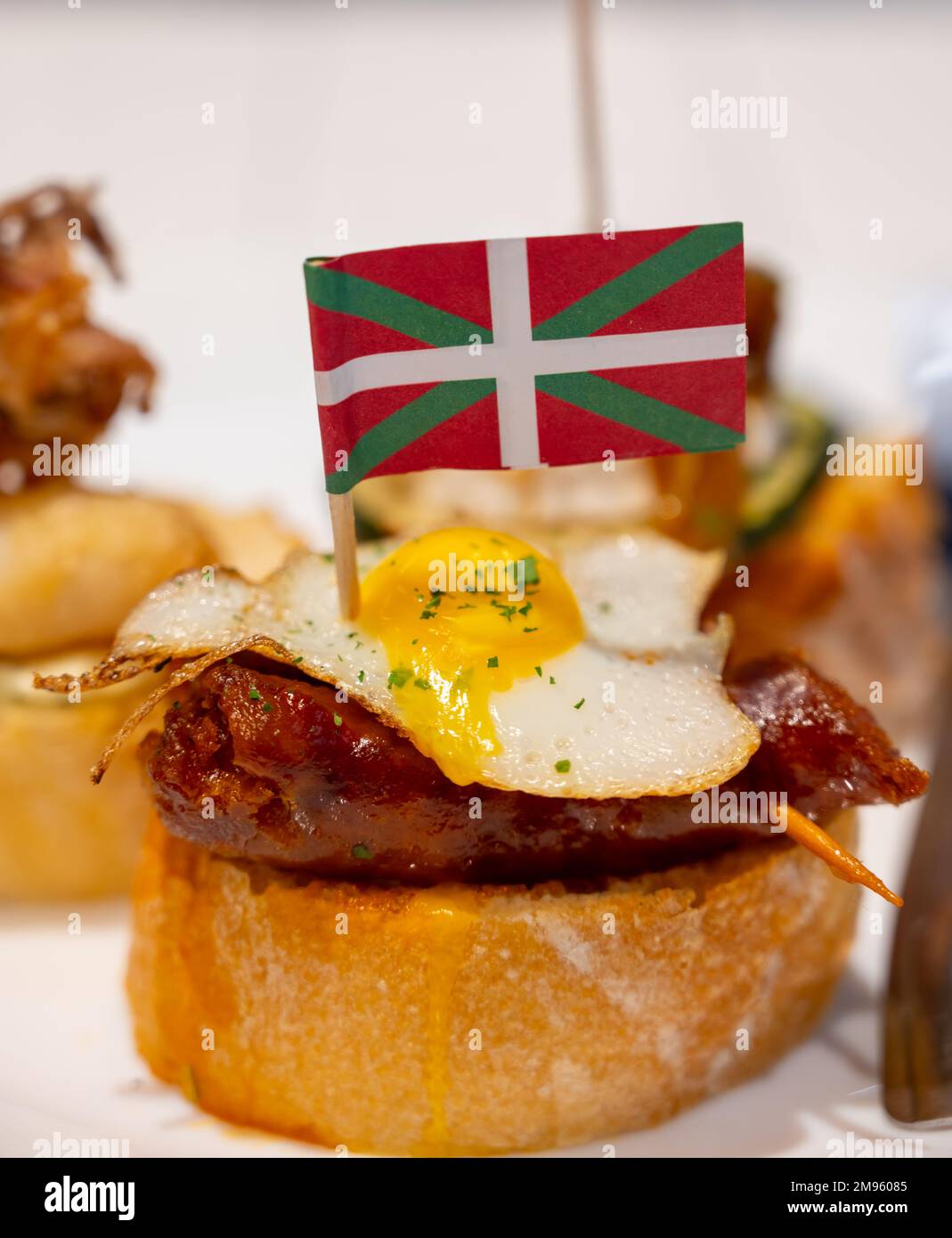 White board with typical snack and flag of Basque Country, pinchos or ...