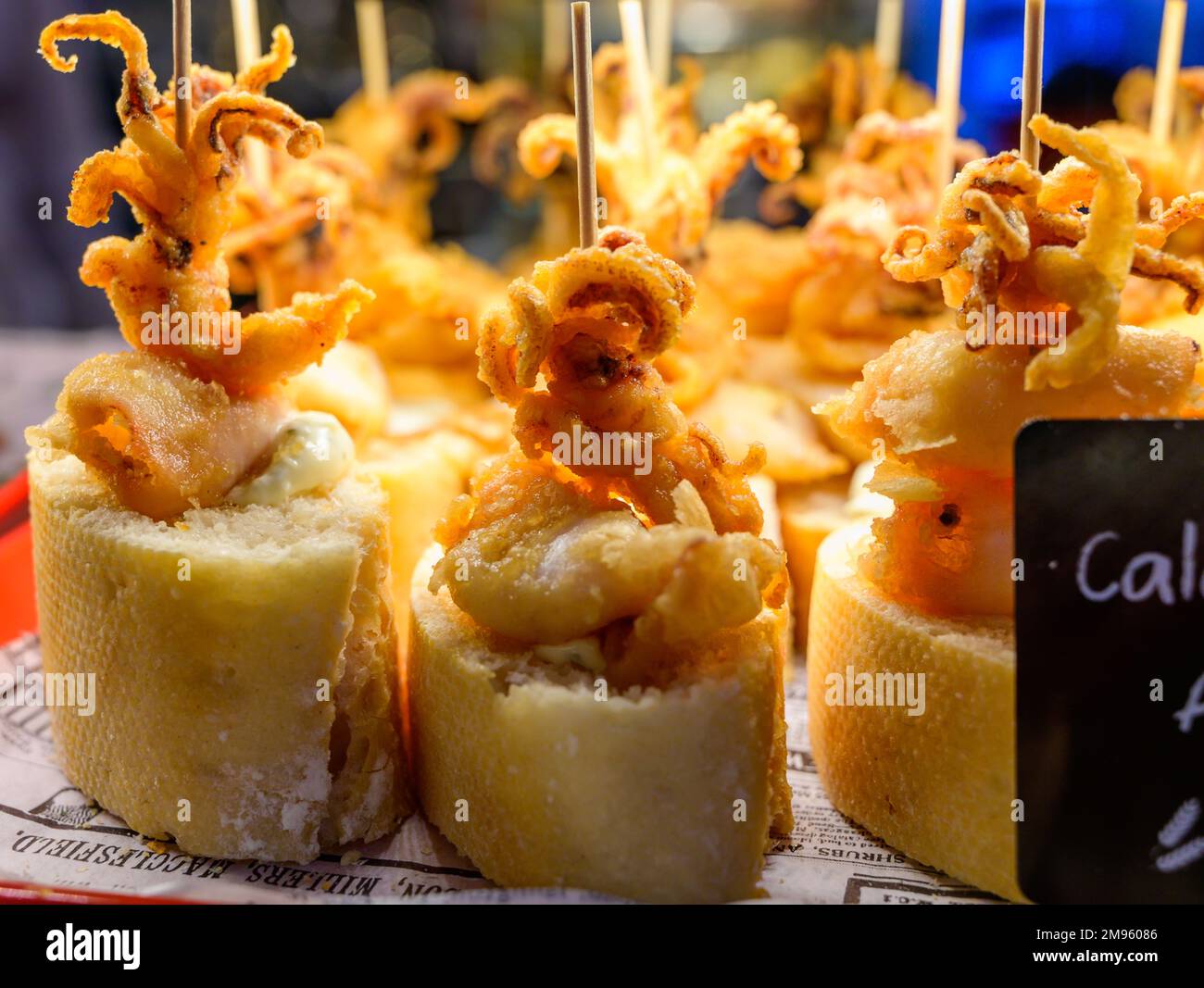 Typical snack of Basque Country, pinchos or pinxtos skewers with small ...