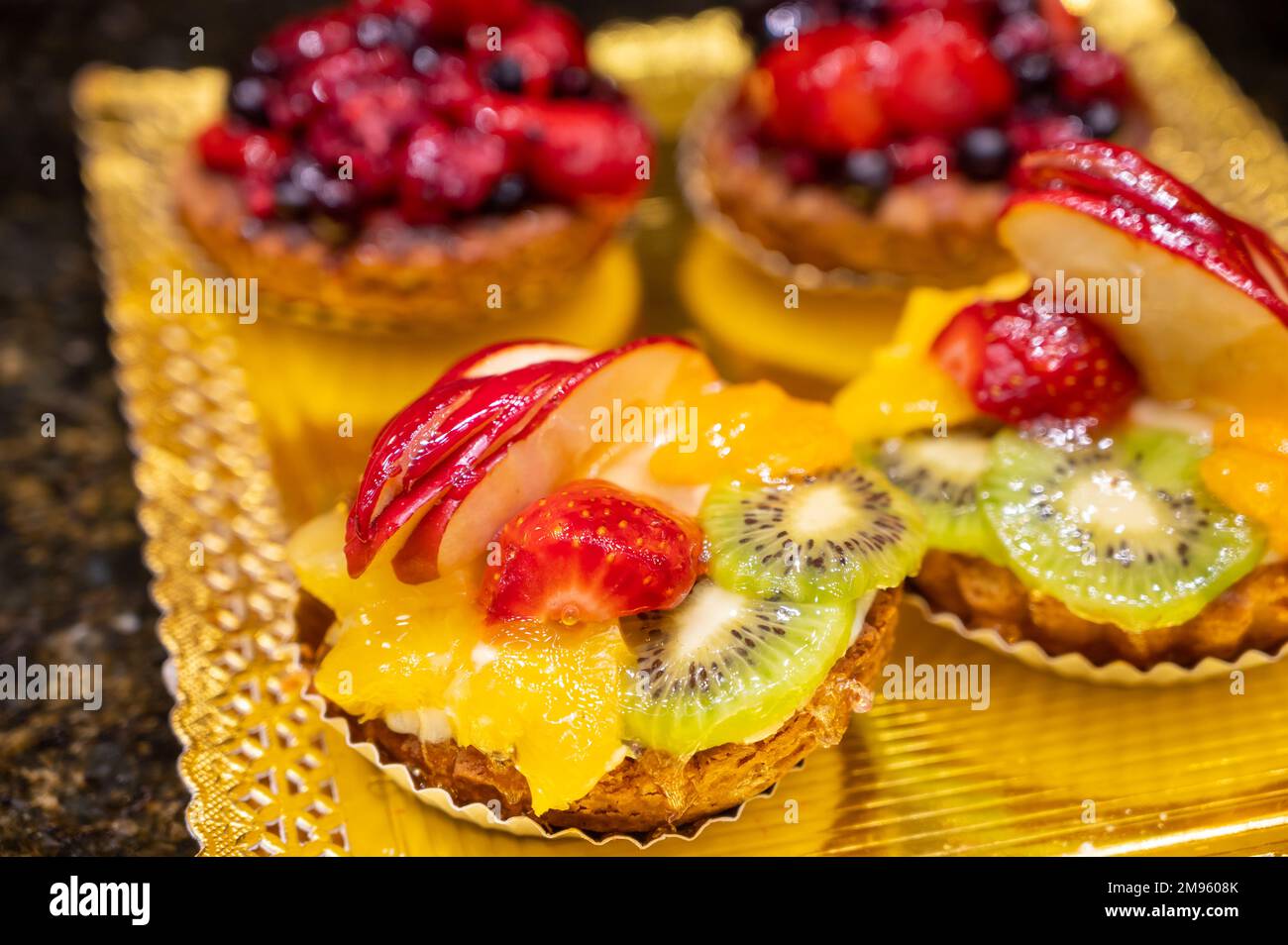 Delicious fresh baked colorful decorated cakes, tarts with cream and ...