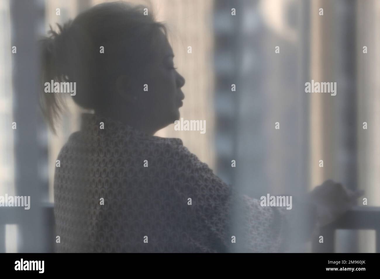 Silhouette of a woman behind a semi transparent curtain Stock Photo - Alamy