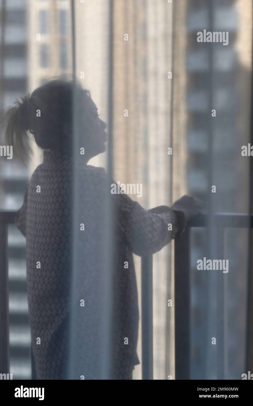 Silhouette of a sad woman behind a semi transparent curtain. Depression ...