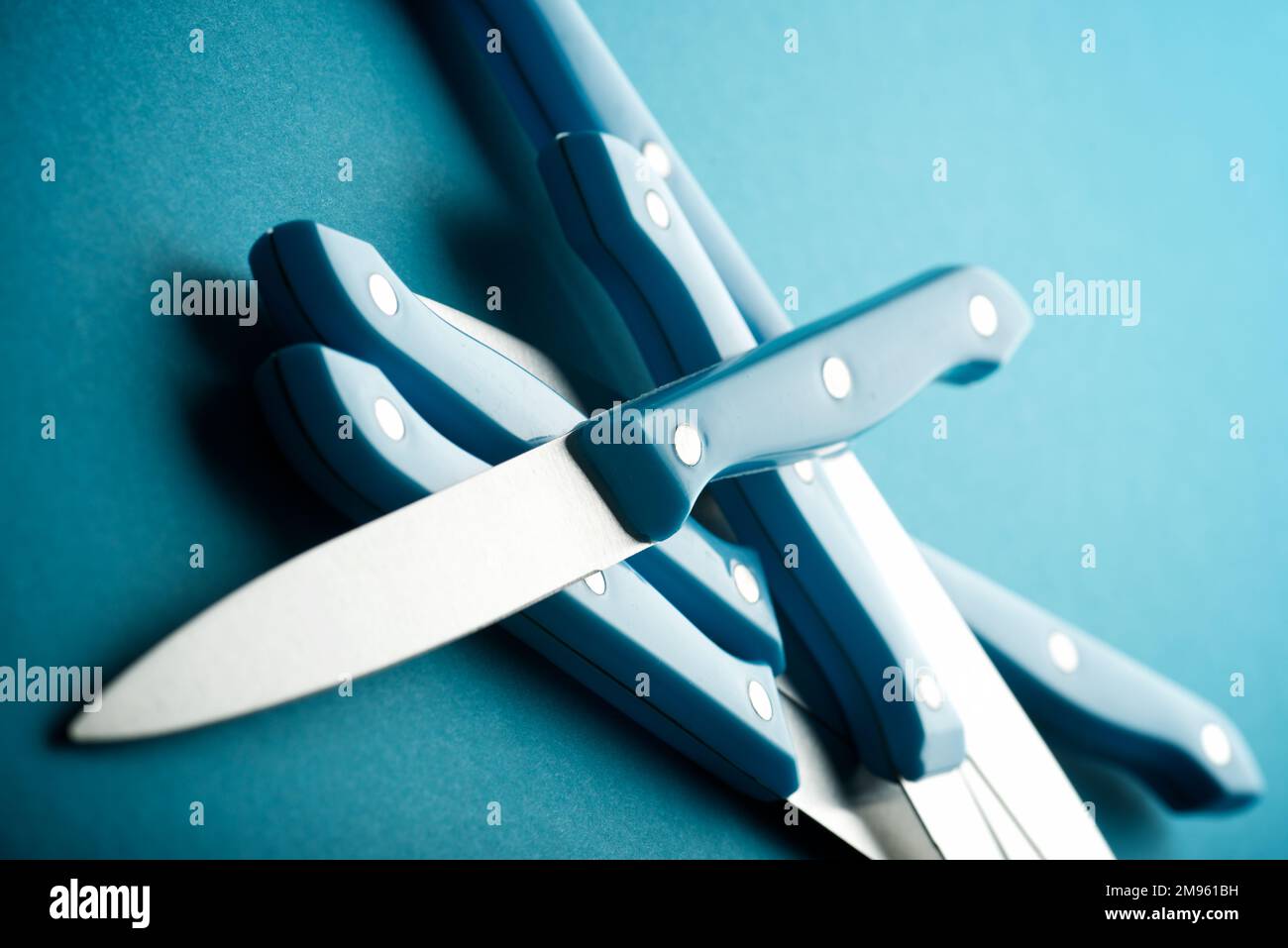 Kitchen knives with blue plastic handles Stock Photo - Alamy