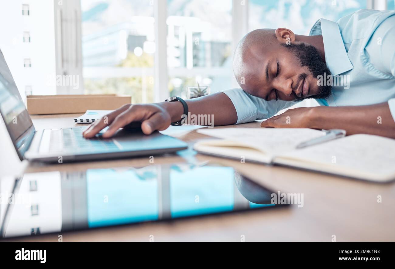 Feeling overworked is no joke. an exhausted businessman taking a nap at ...