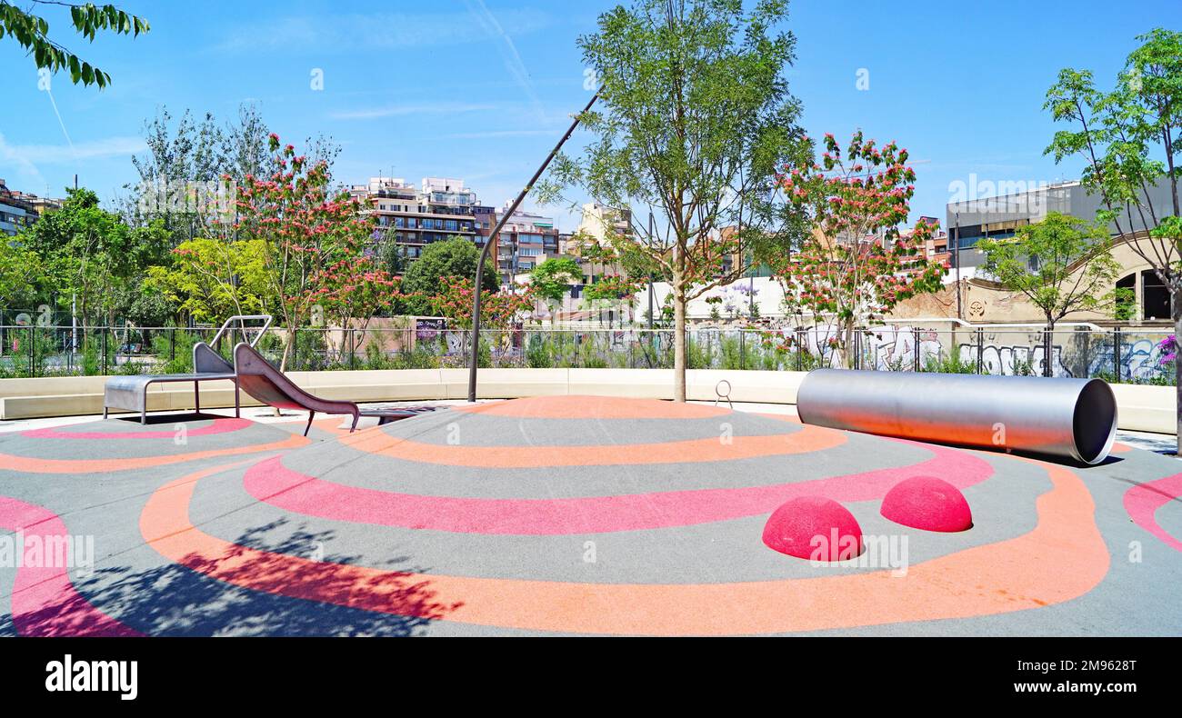 slides and swings in a playground in a neighborhood of Barcelona ...
