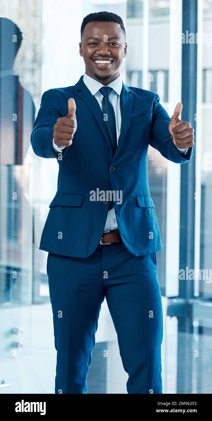 Good job on getting it done. a young businessman showing thumbs up in a ...