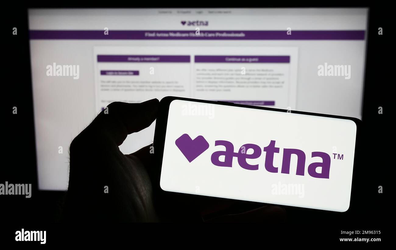 Person holding mobile phone with logo of American managed healthcare ...