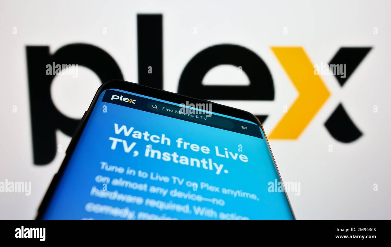 Smartphone with website of US video streaming company Plex Inc. on screen in front of business ...