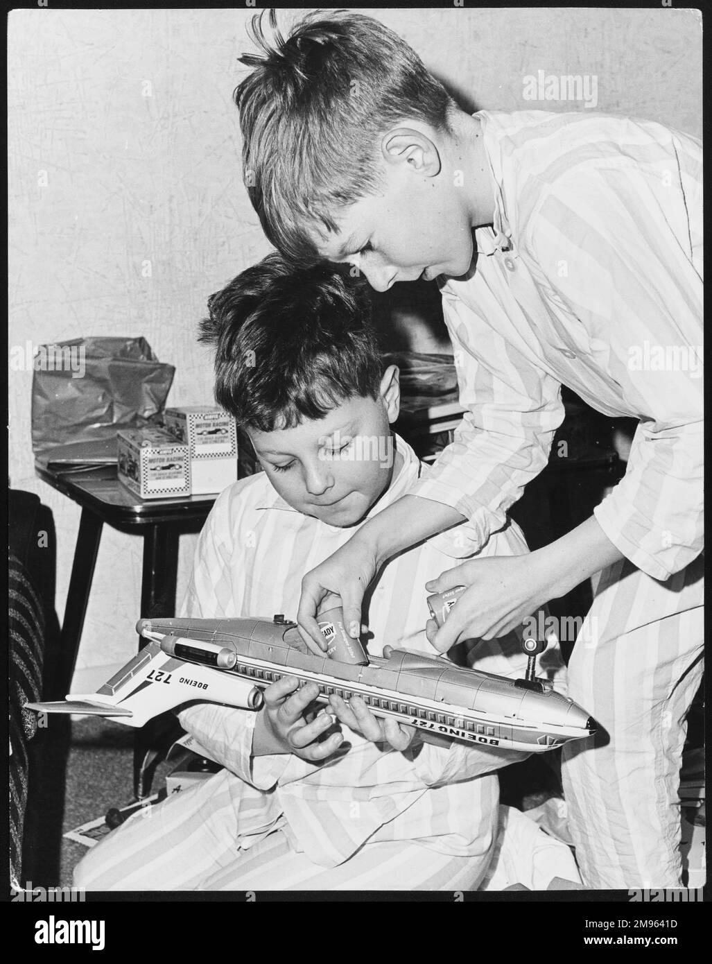 Two young boys, brothers, wearing stripy pyjamas, perhaps on Christmas ... Two young boys, brothers, wearing stripy pyjamas, perhaps on Christmas ...