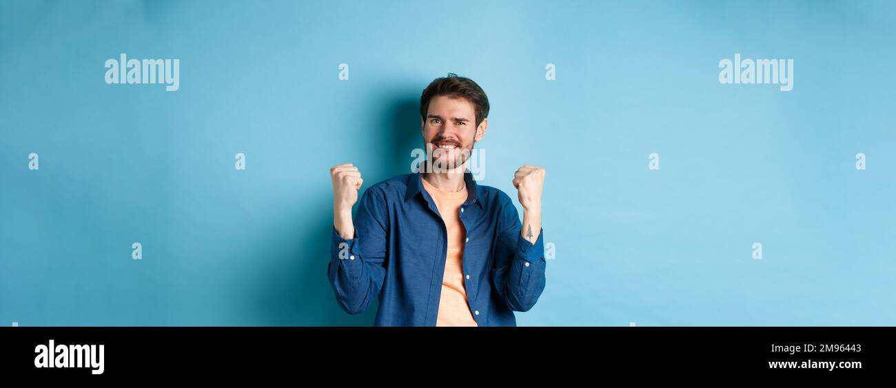 Image of happy man celebrating success, shouting yes and shaking ...