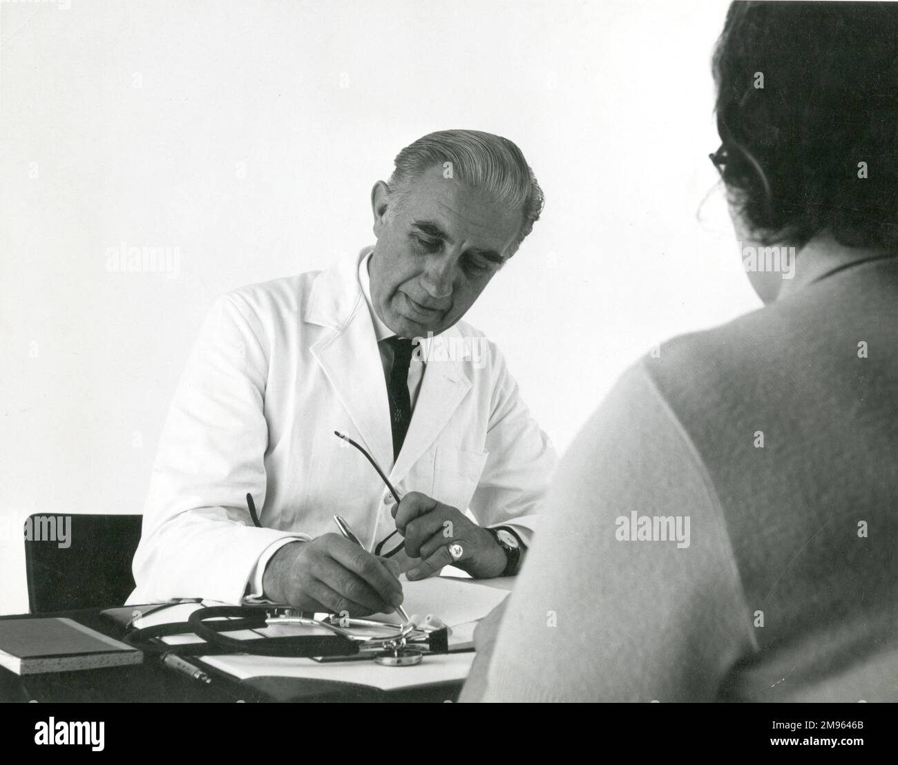 1960s doctor at desk hi-res stock photography and images - Alamy