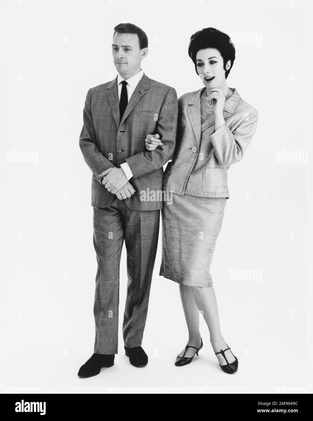 Full-length portrait of a suited couple Stock Photo - Alamy