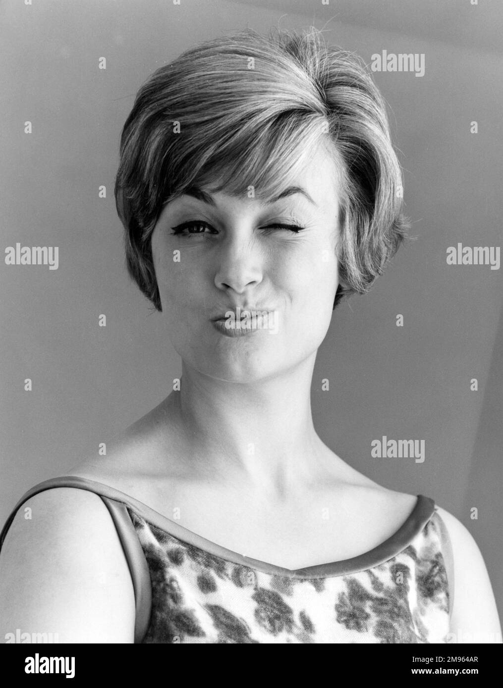 A head and shoulders portrait of a woman winking Stock Photo - Alamy