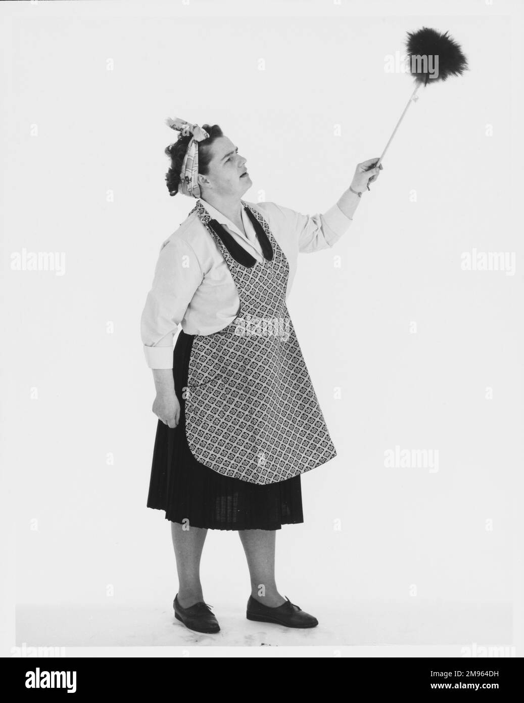 A stereotypical cleaner doing some feather dusting Stock Photo - Alamy