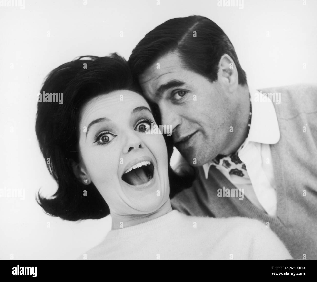 An hysterical looking woman poses with a close friend Stock Photo - Alamy