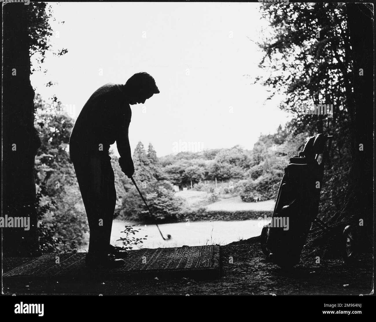 Silhouette golfer teeing off Stock Photo - Alamy